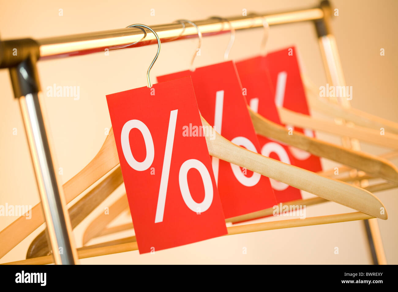 Image of several wooden hangers with red labels showing discount on ...