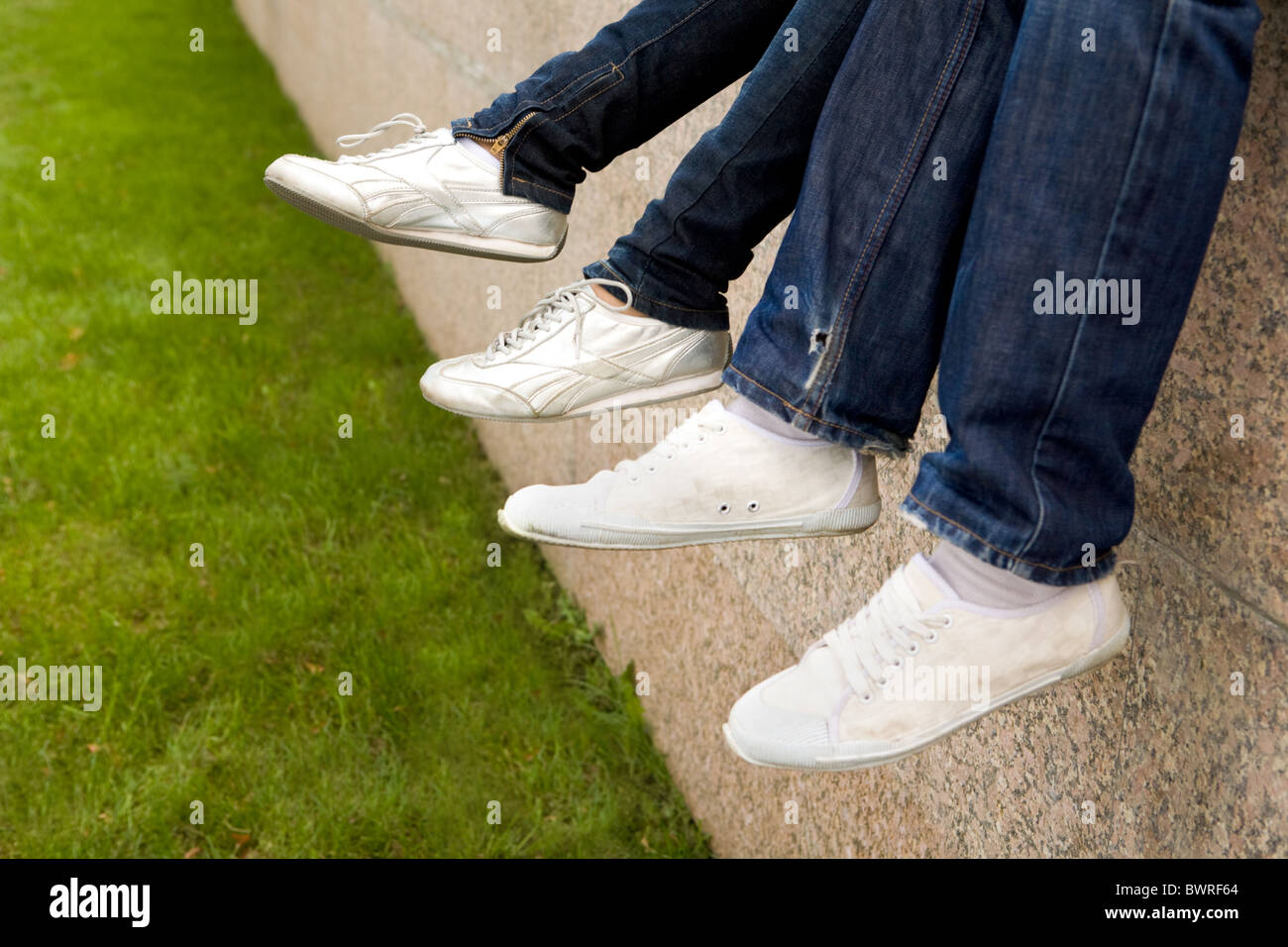 Close-up of two pairs of feet wearing sportive shoes Stock Photo - Alamy