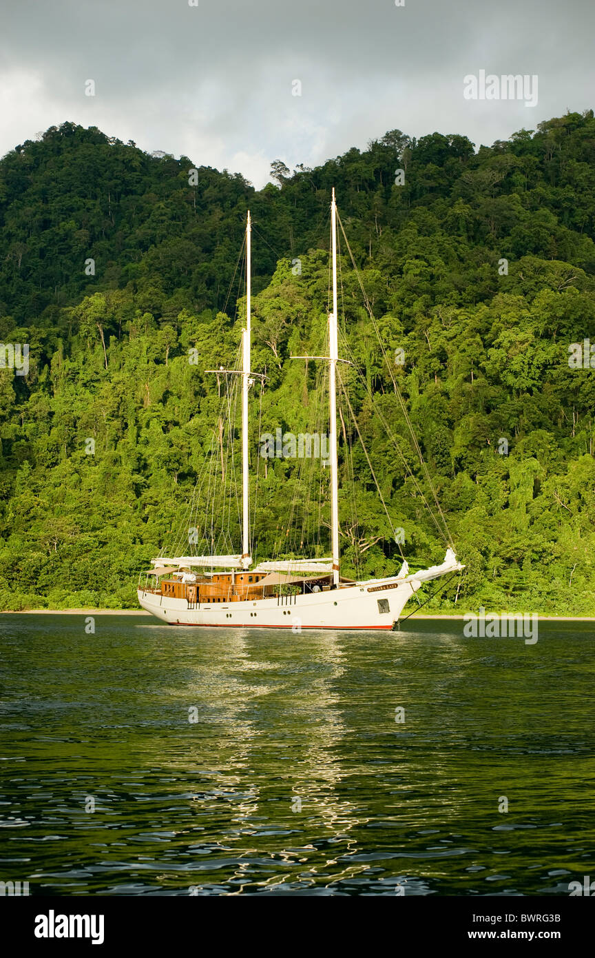 Scenic view of Batanta Island and a sailing boat, Raja Ampat Indonesia ...