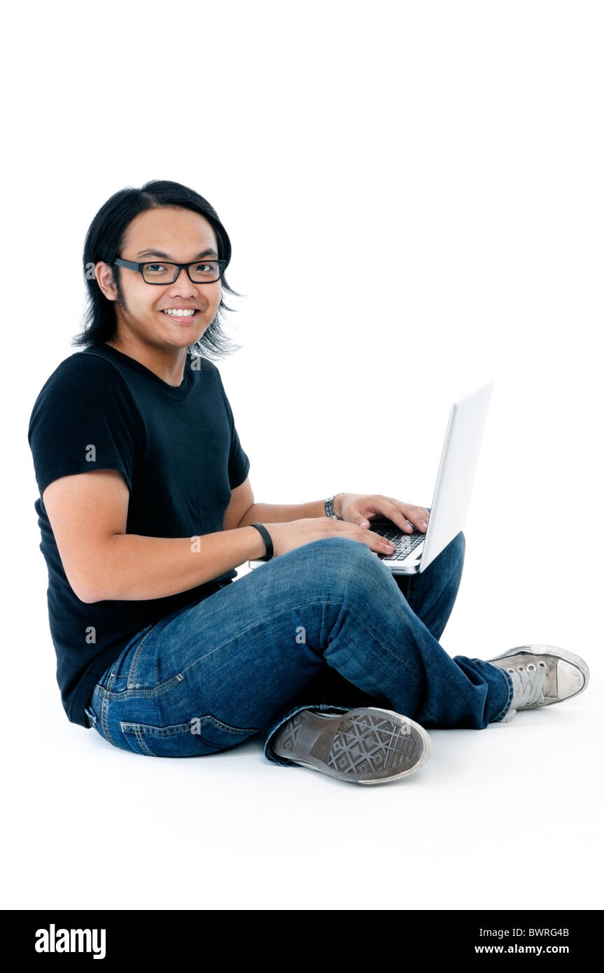 Handsome young man sitting on floor with a laptop Stock Photo - Alamy