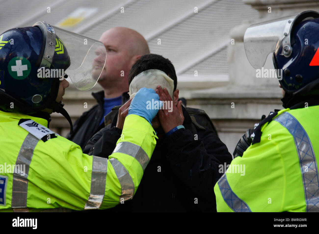 Police medic treating a injured student protester Stock Photo - Alamy