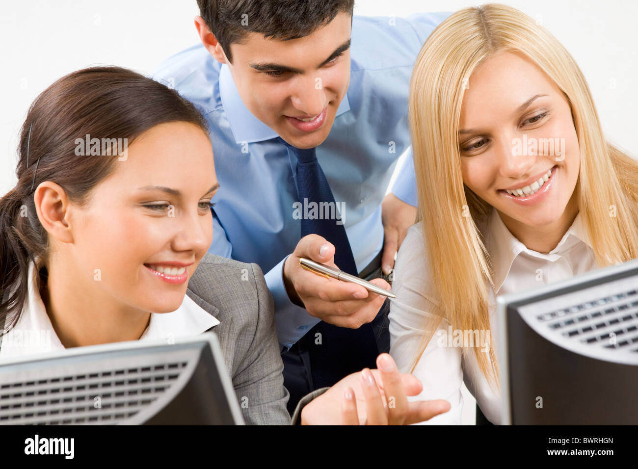 Successful businessman explaining something to his pretty colleagues ...