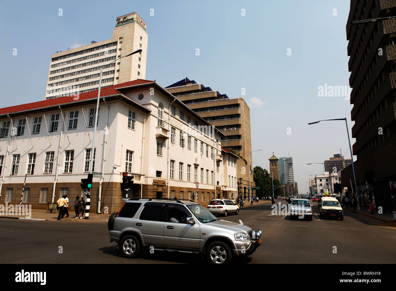 Traffic at a crossroads in central Harare, Zimbabwe. Since ...