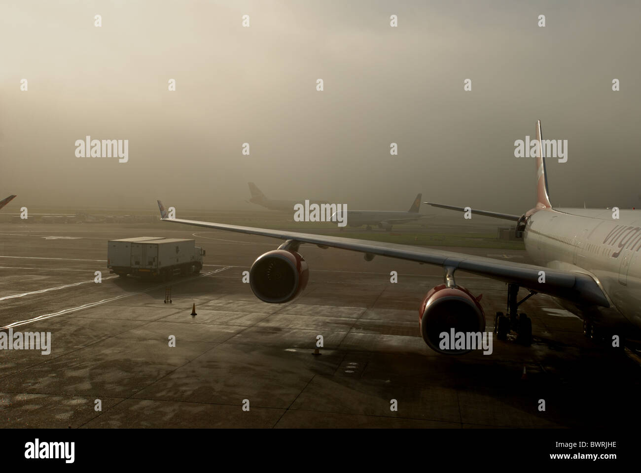 Airplanes in fog at Heathrow Airport, London, UK Stock Photo - Alamy