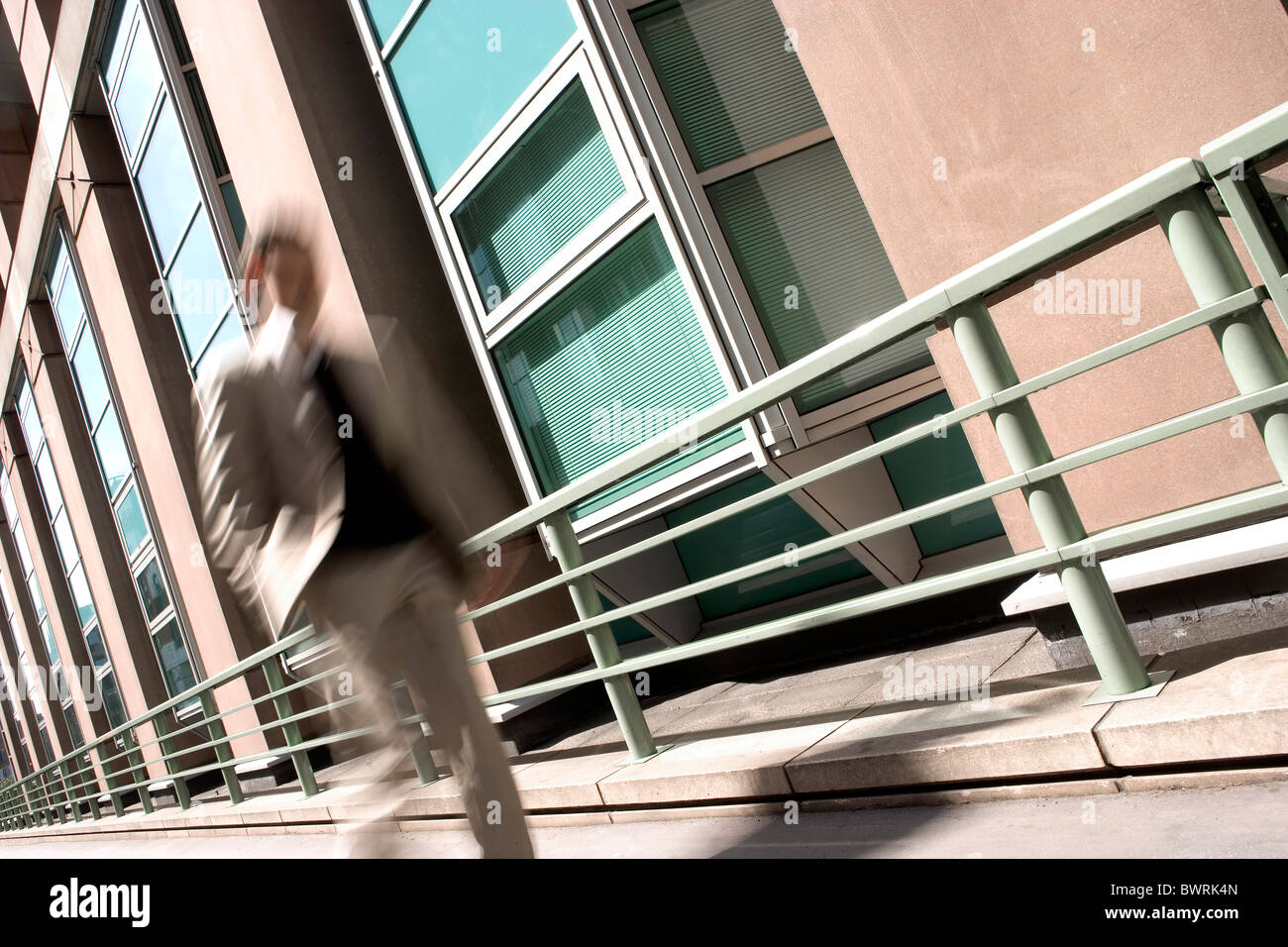 single male in motion with office background Stock Photo - Alamy