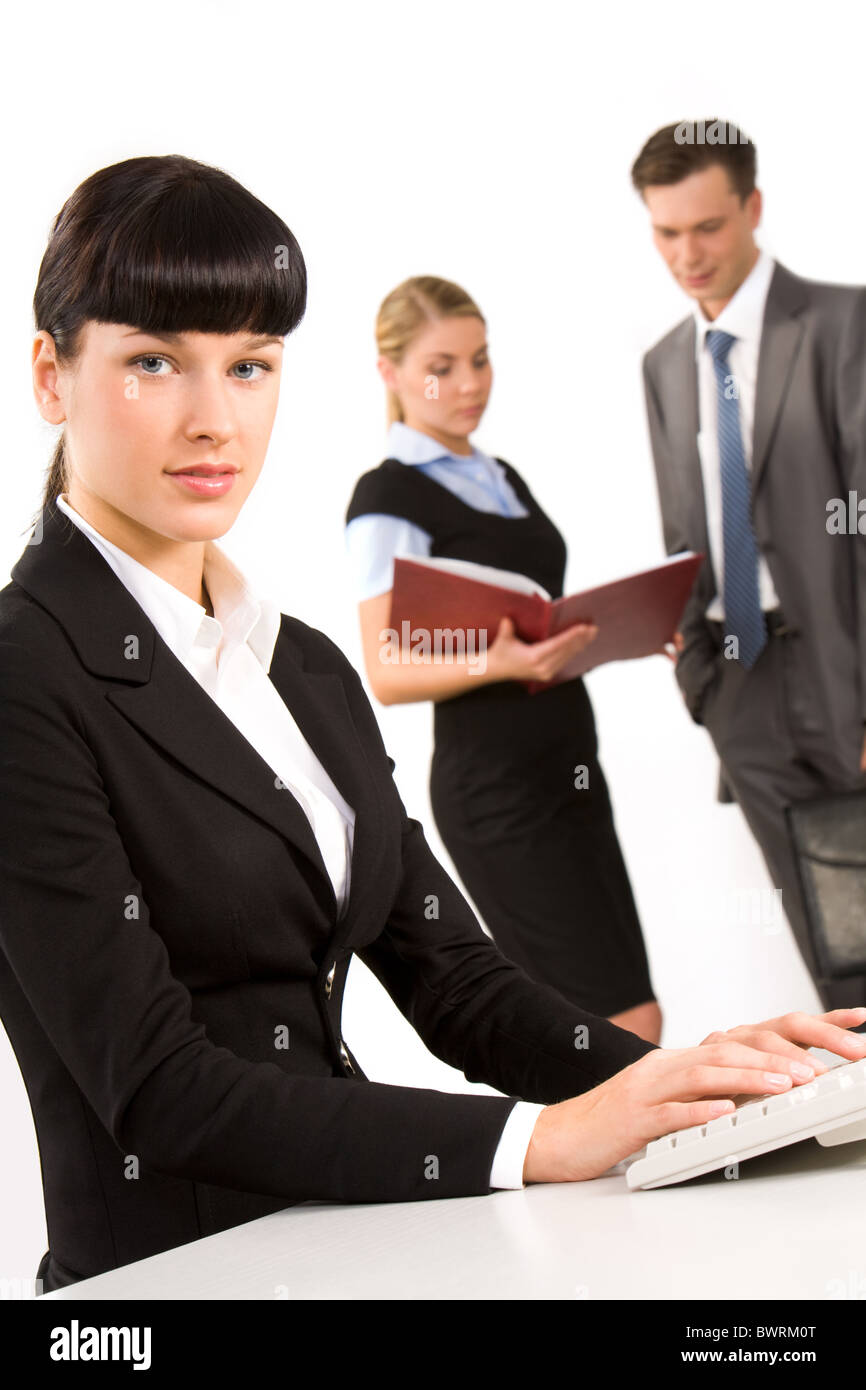 Portrait of smart secretary looking at camera on background of people ...