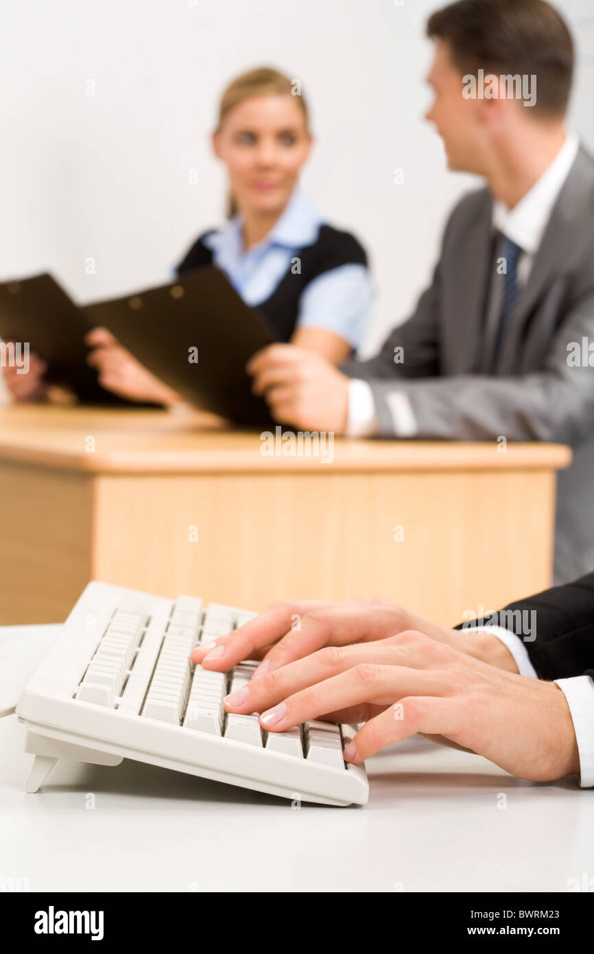 Vertical photo of female’s hands pushing buttons of computer keyboard ...