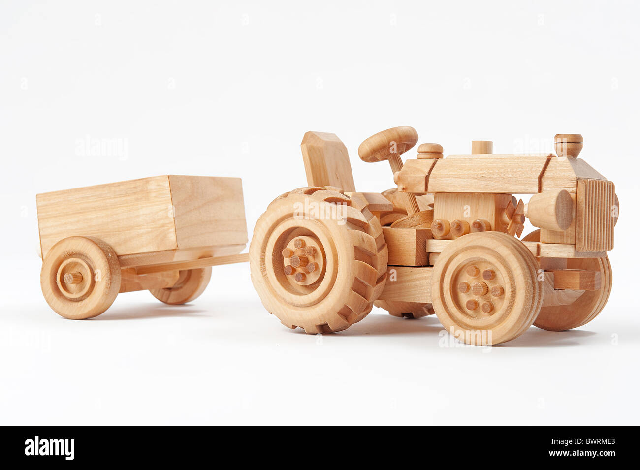 Wooden toy tractor with trailer on white isolated background Stock ...