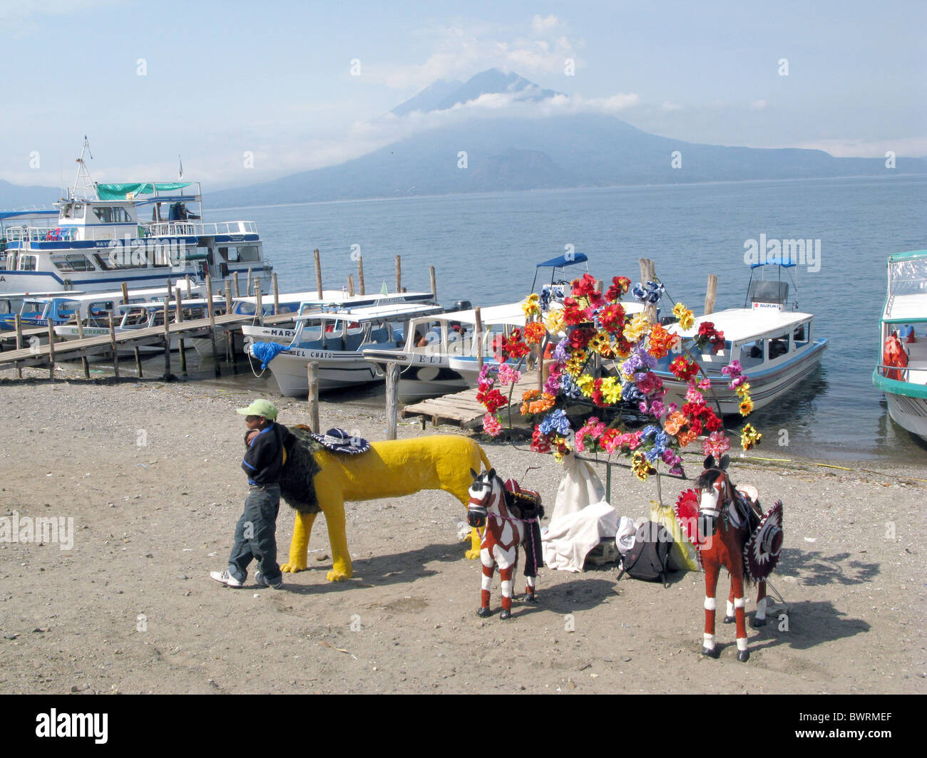GUATEMALA Native Quiche children selling souvenirs to tourists on lake ...