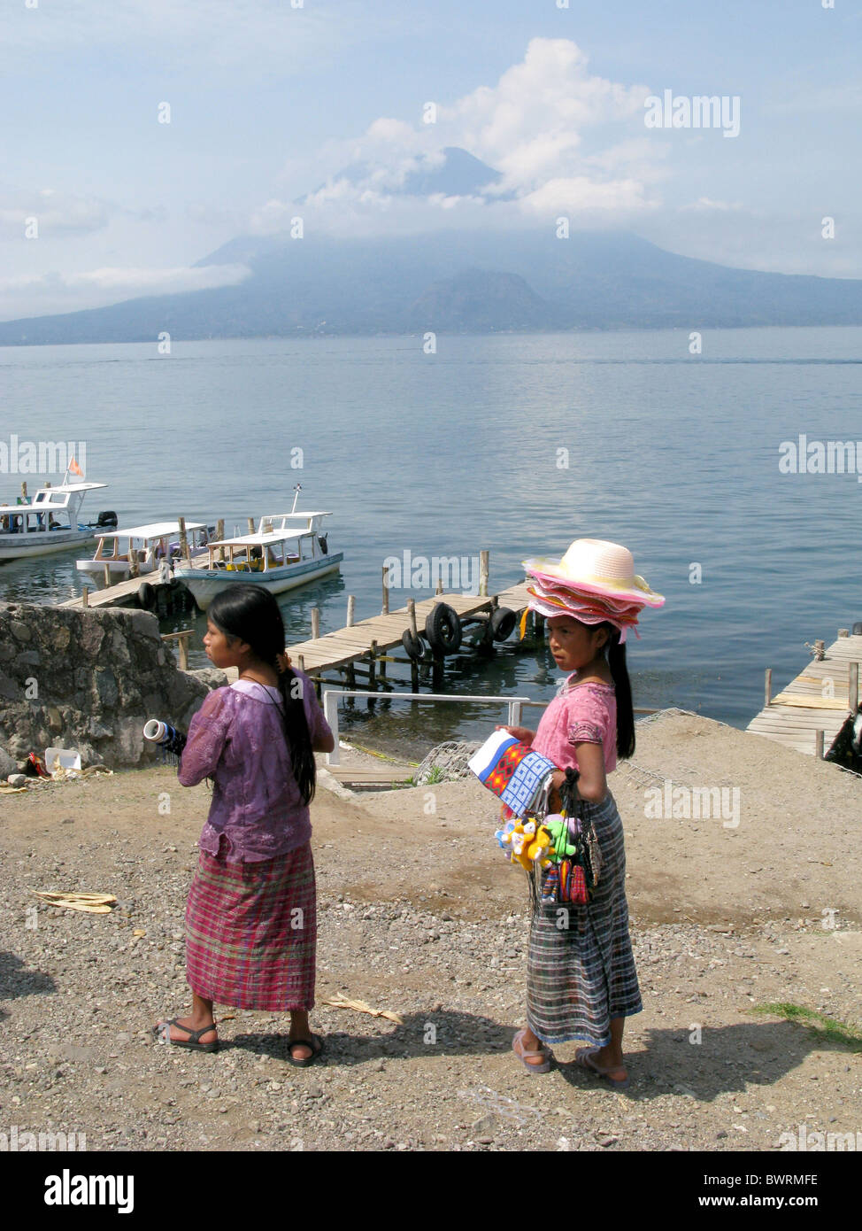 GUATEMALA Native Quiche children selling souvenirs to tourists on lake ...