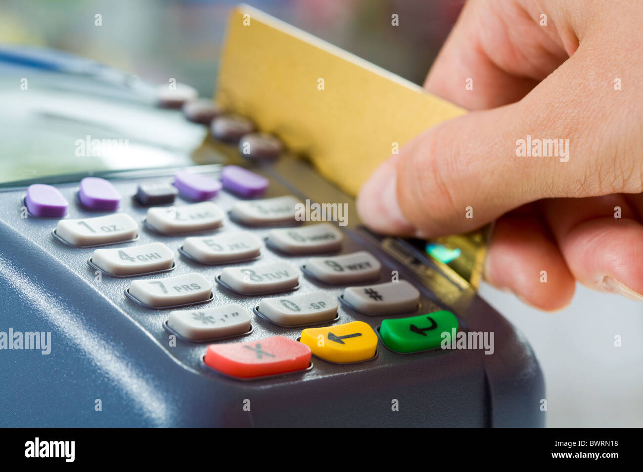 Close-up of payment machine buttons with human hand holding plastic ...