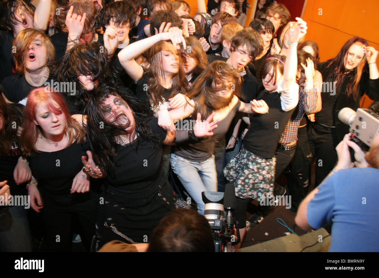 Metal fans at a music video shoot/gig Stock Photo - Alamy