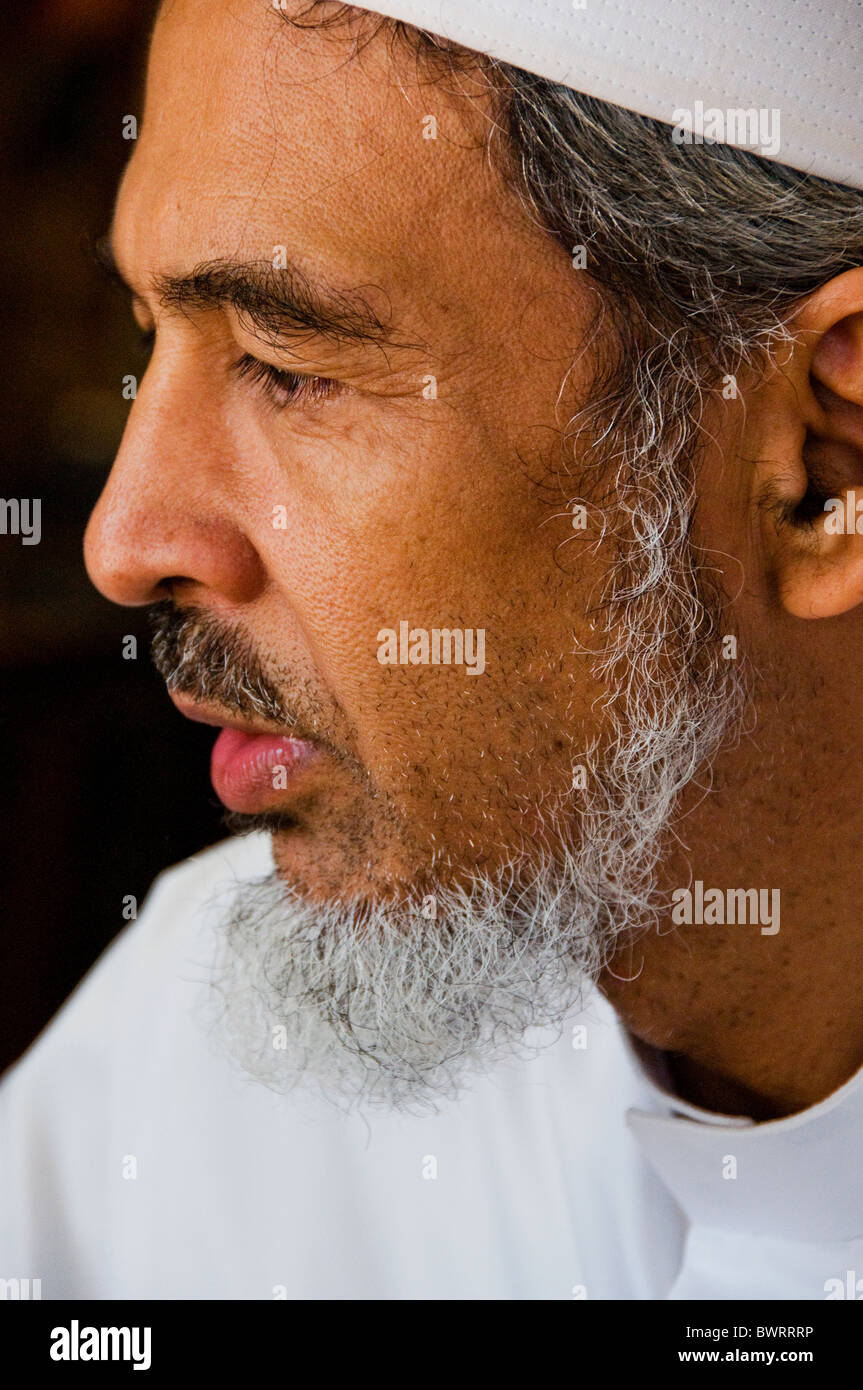 Distinguished older Muslim man in shop in Arab quarter Singapore Stock ...
