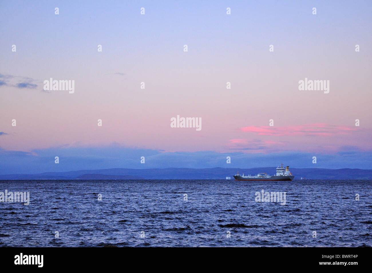 Ship at sea at sunset, Firth of Clyde, Scotland, UK Stock Photo - Alamy