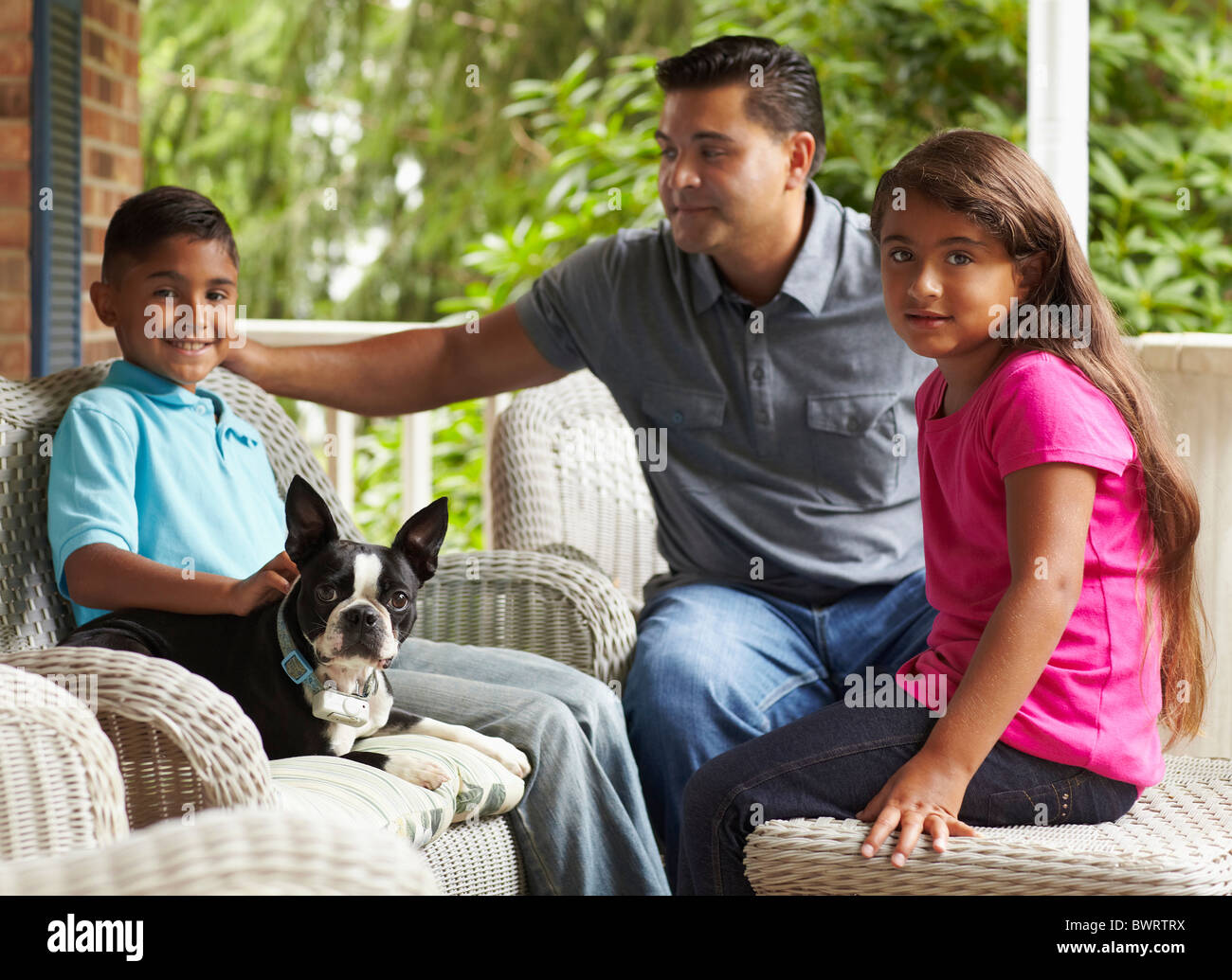 Father and children sitting on porch with dog Stock Photo - Alamy