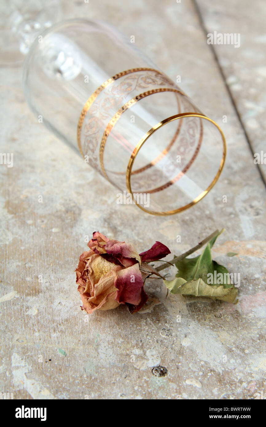 empty glass and a dry rose flower on a wooden background Stock Photo ...