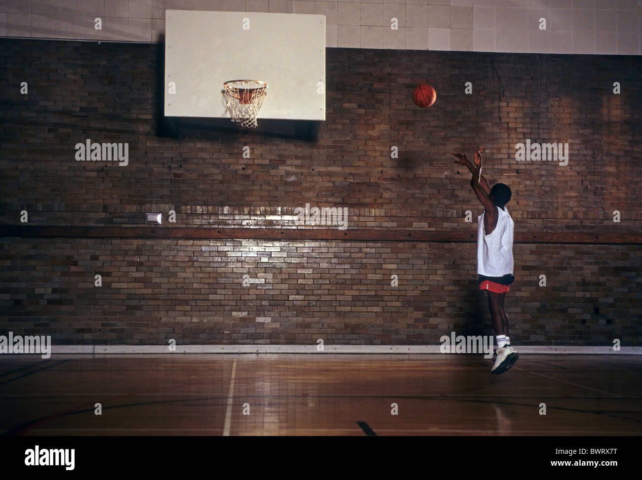Young boy practicing his basketball shooting Stock Photo - Alamy