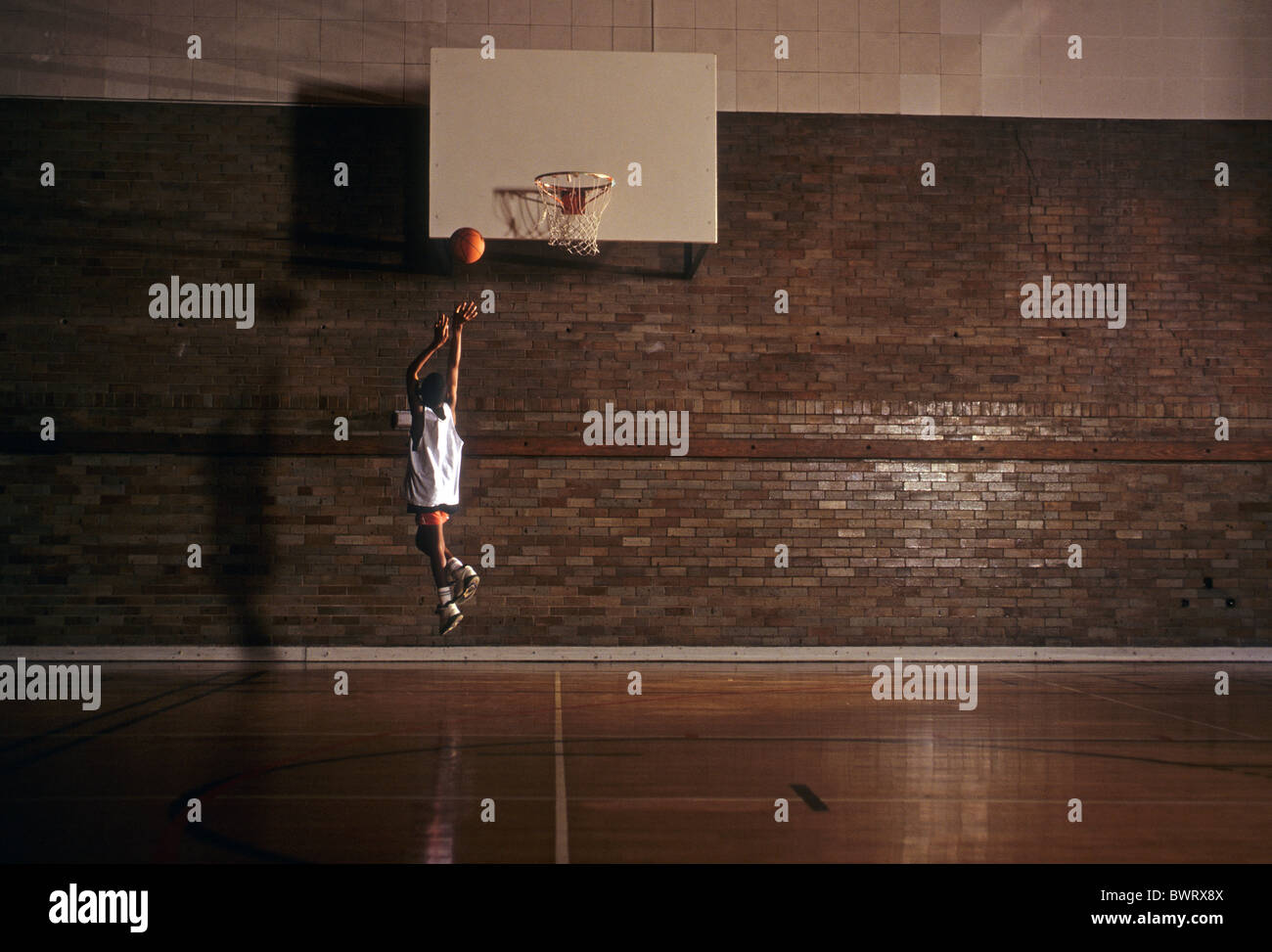 Young boy practicing his basketball shooting Stock Photo - Alamy