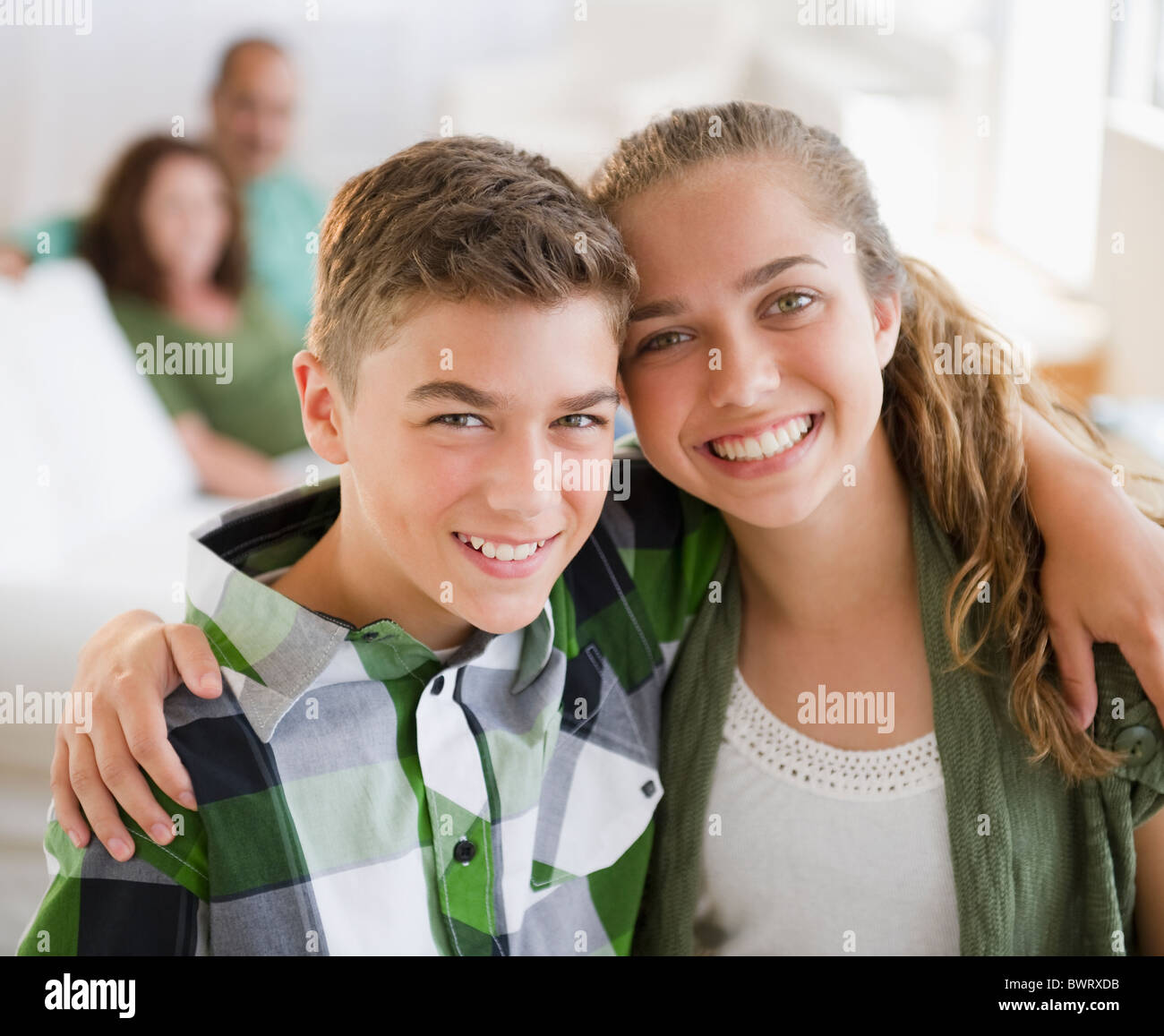 Hispanic brother and sister hugging Stock Photo - Alamy