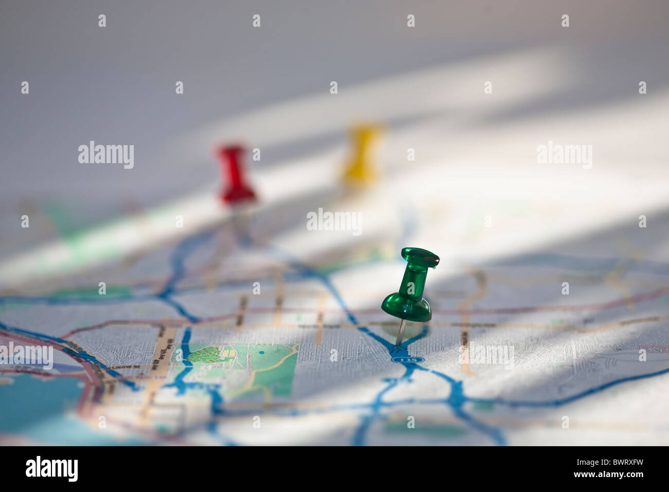 colored push-pins in colorful paper map Stock Photo - Alamy