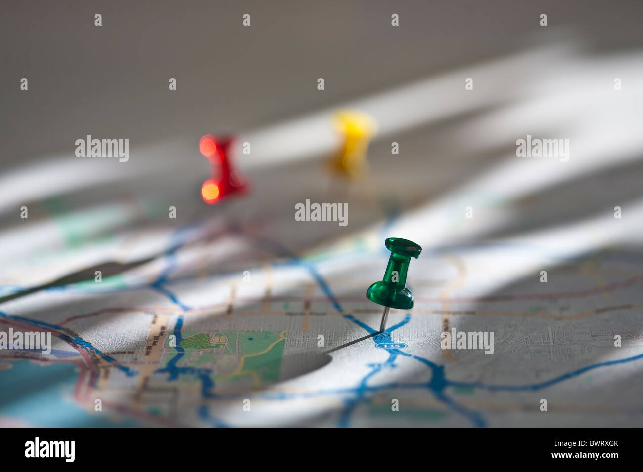 colored push-pins in colorful paper map Stock Photo - Alamy