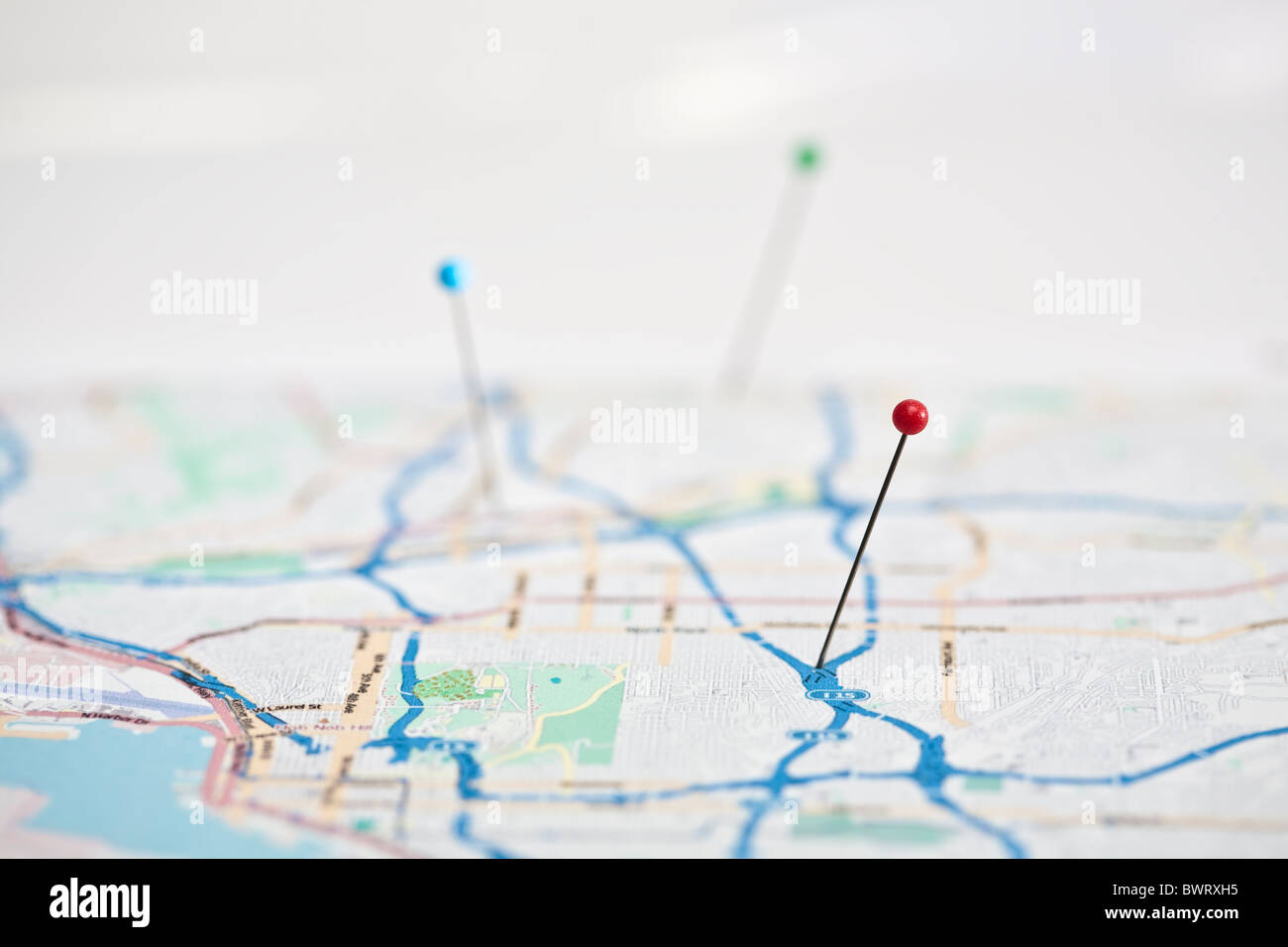 colored map pins in colorful paper map Stock Photo - Alamy