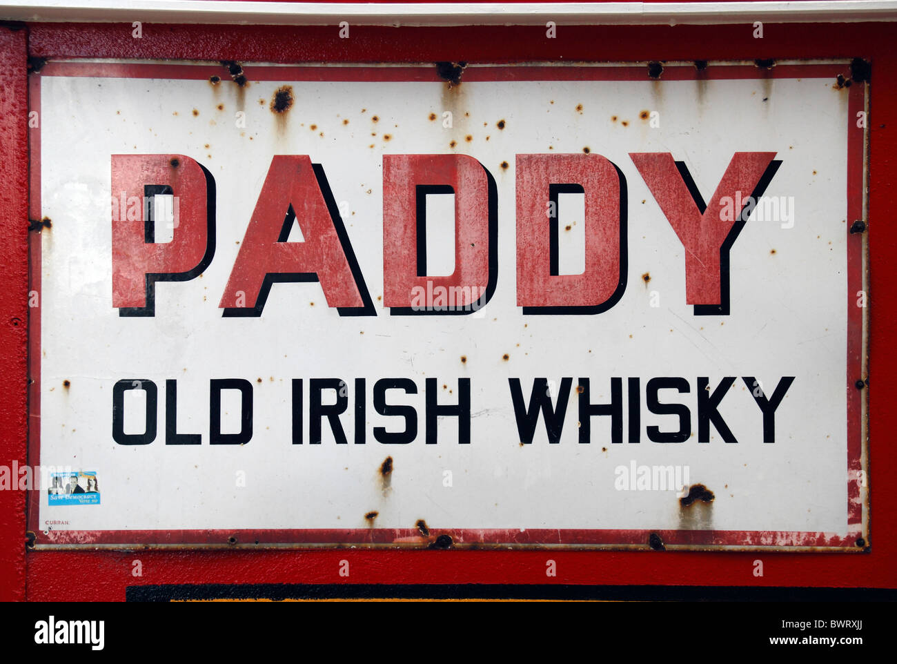An old fashioned metallic sign advertising Paddy Old Irish Whisky, in ...