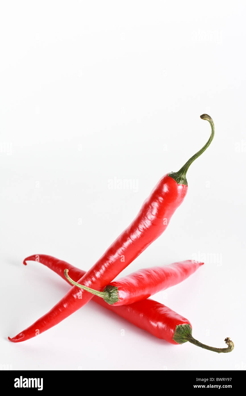 Three red hot chili peppers Stock Photo - Alamy