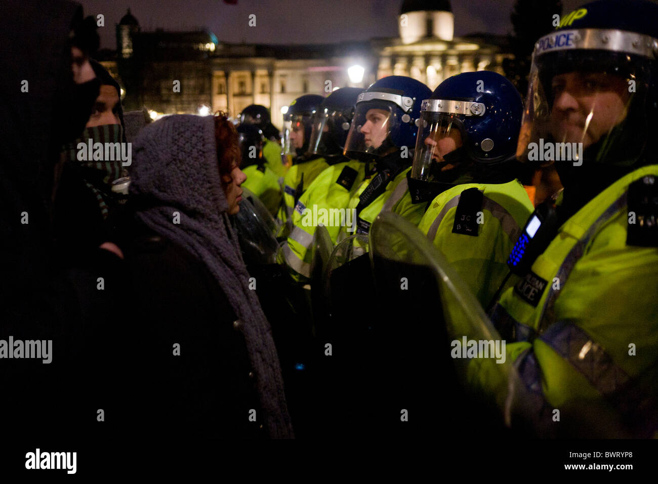 Met police riot officers confronted by student protesters in Trafalgar ...
