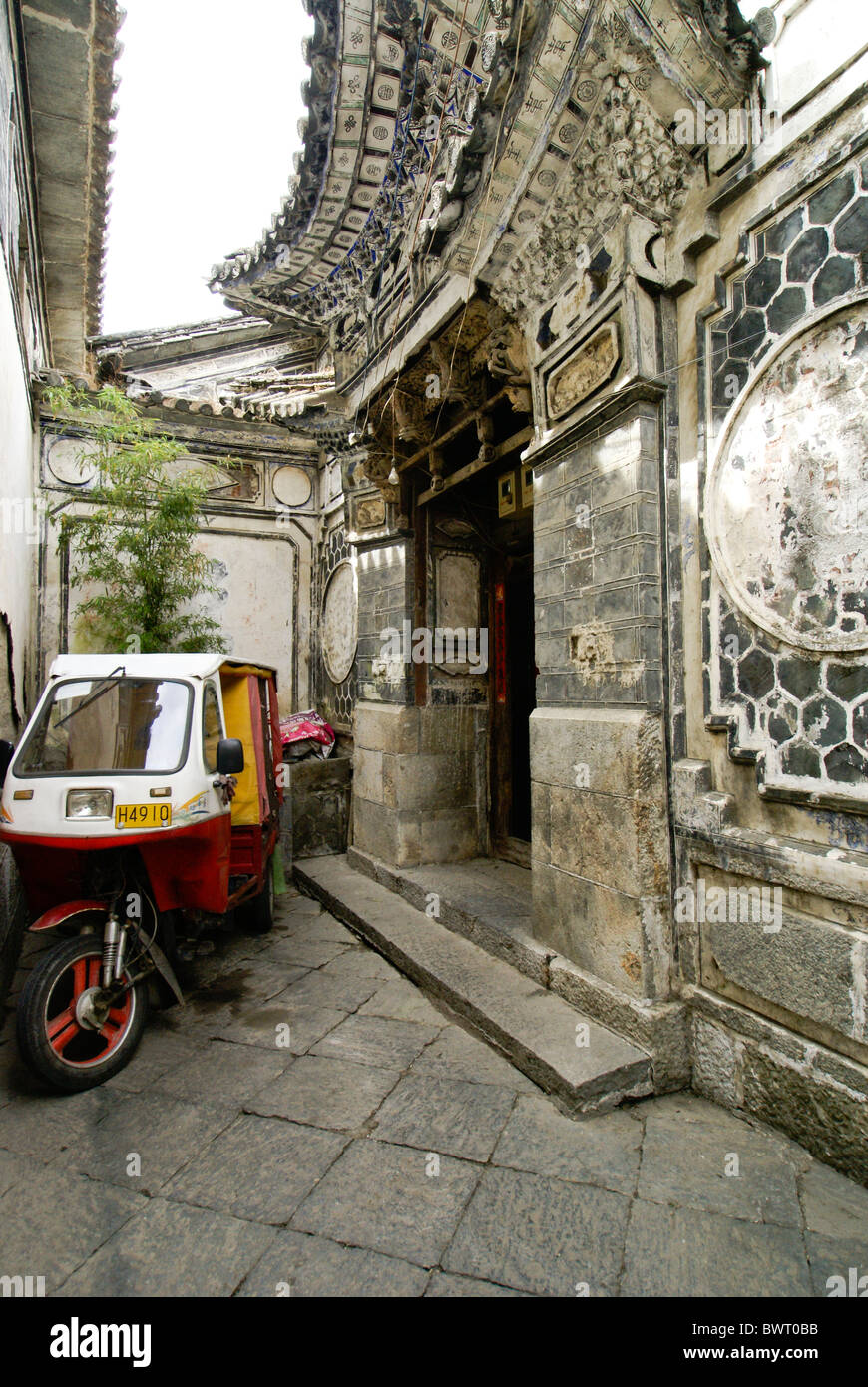 Motorcycle cart in courtyard of old Bai house, Xizhou, Yunnan, China ...