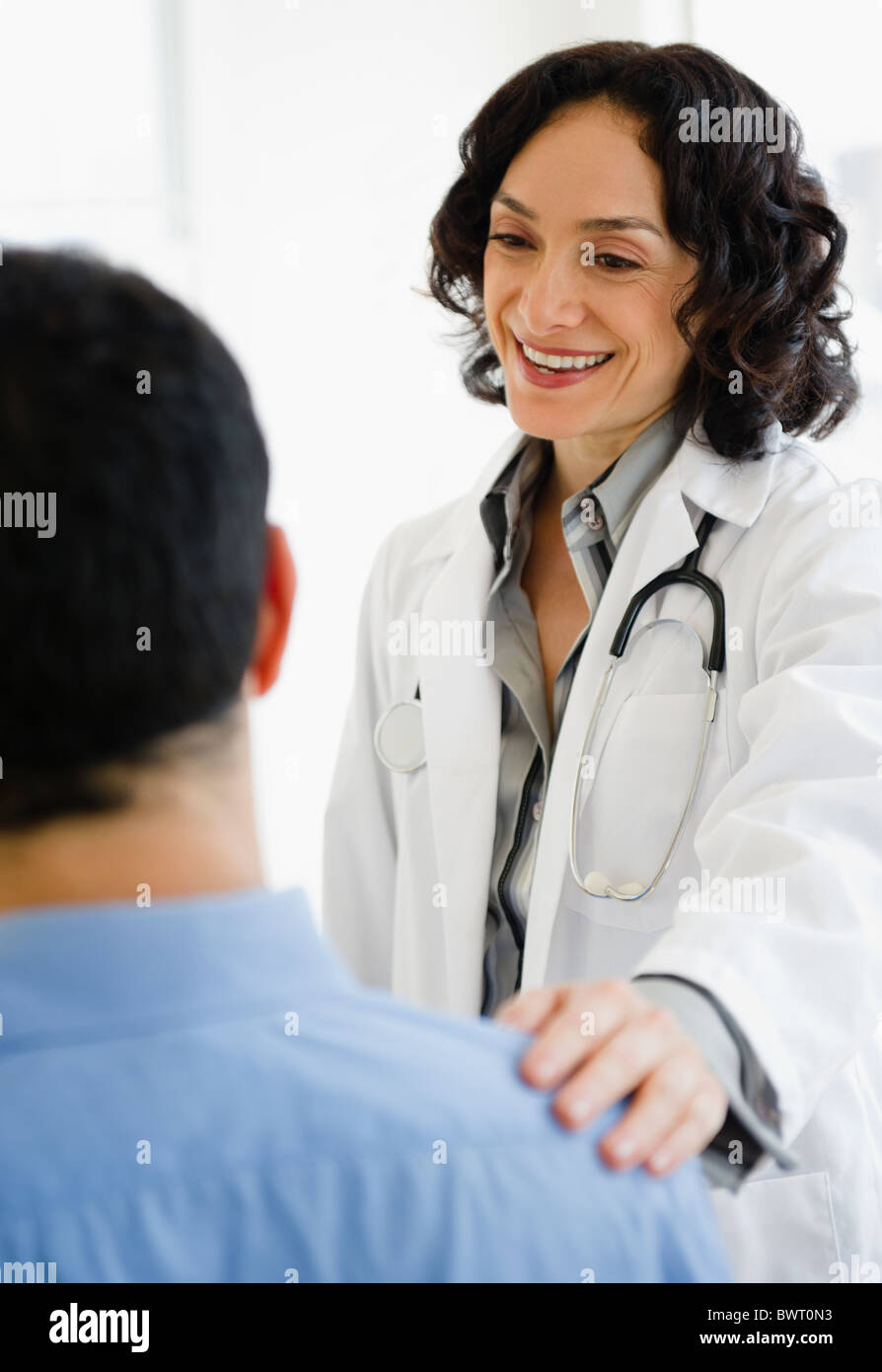 Hispanic doctor talking to patient in doctor's office Stock Photo - Alamy