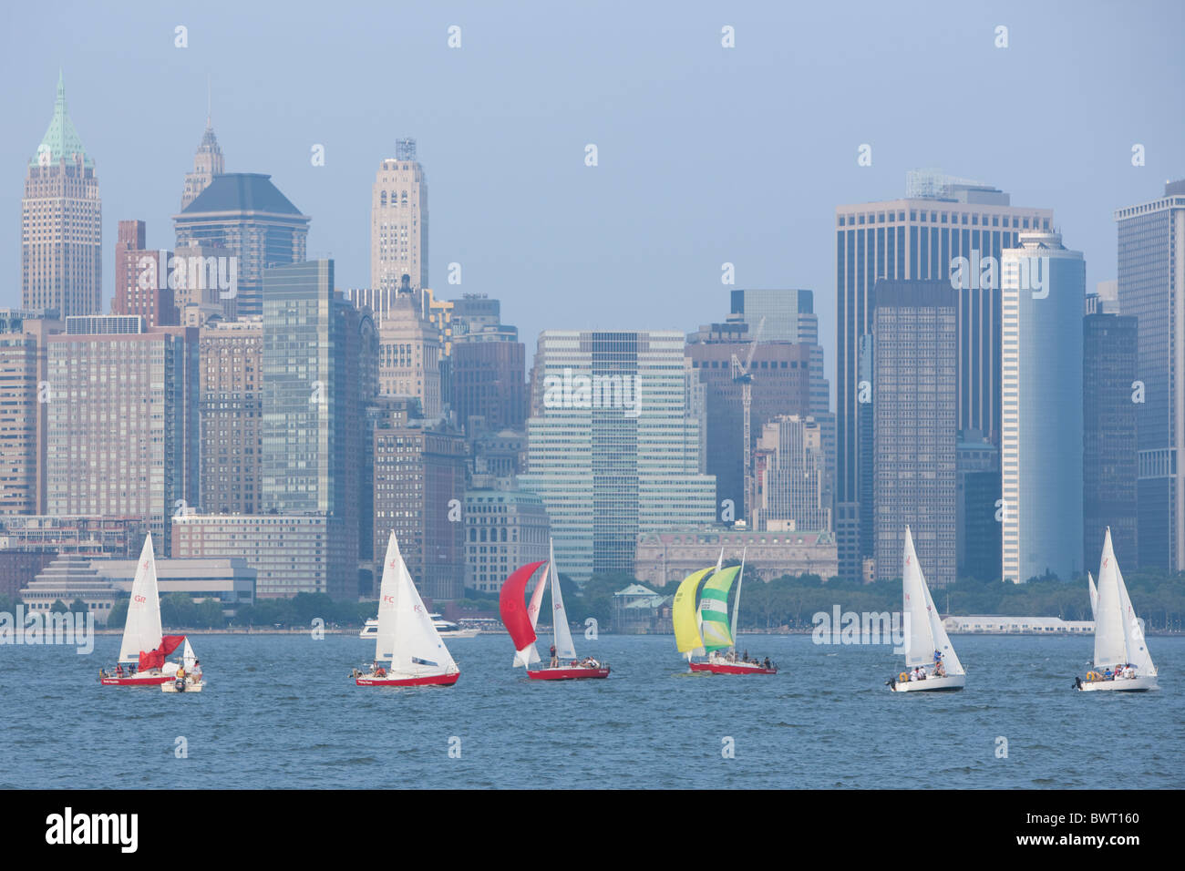 Sailboats sail on the Hudson River in front of the lower Manhattan ...