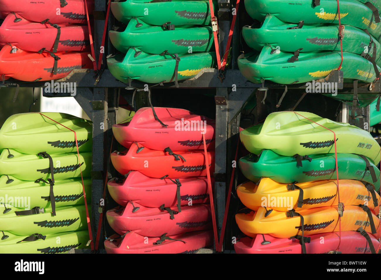 Stacks of rental kayaks of various colors await customers Stock Photo ...