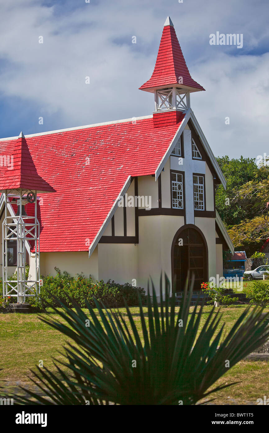 Red-roofed chapel, with some plant leaves in the foreground, at Cap ...