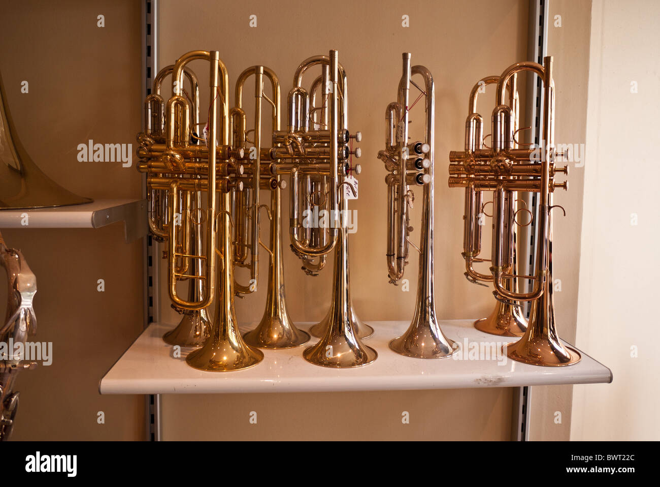 eight trumpets sit on a shelf in a Paris Music shop Stock Photo - Alamy