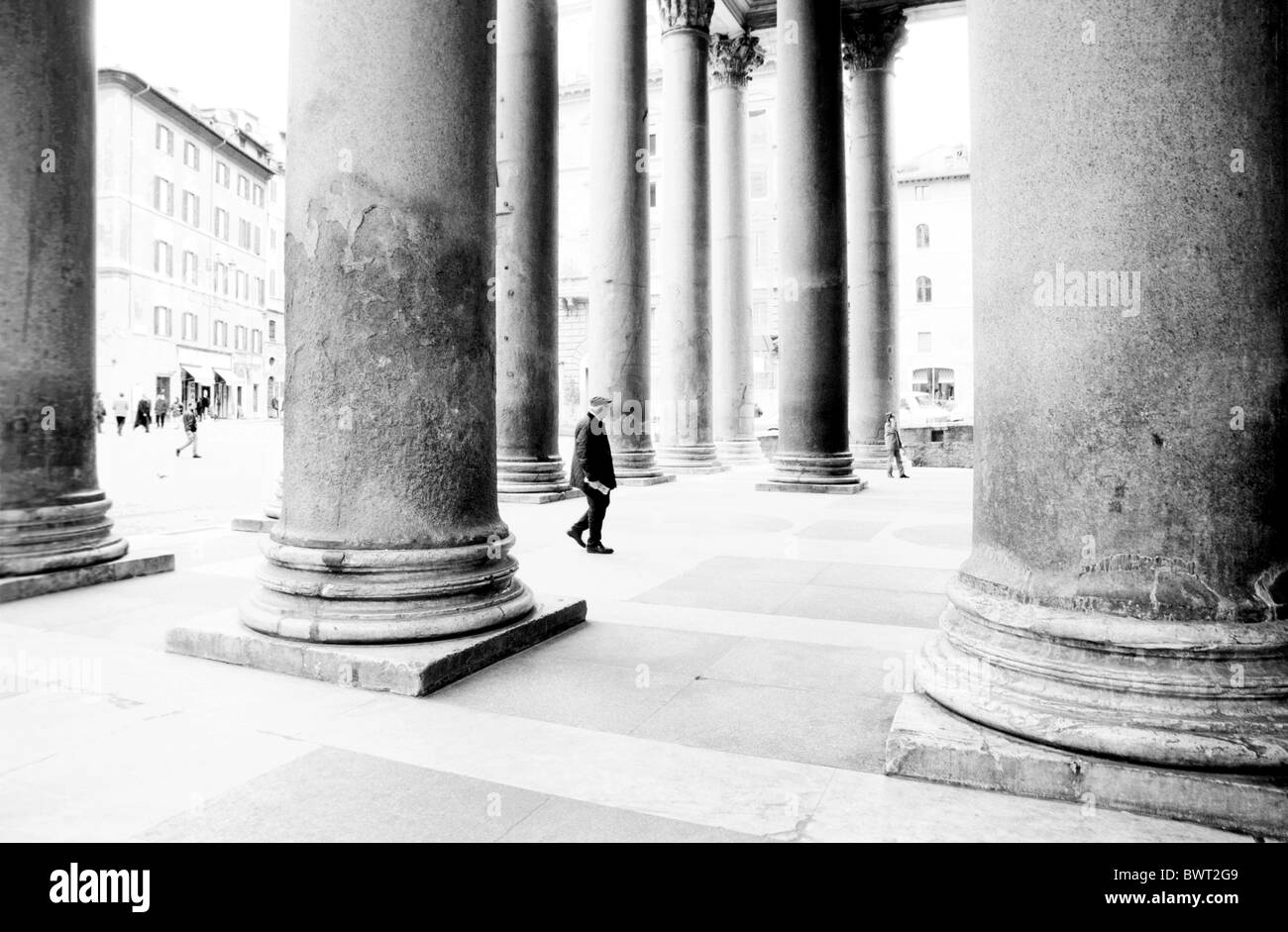 People walking in between the large columns of the Pantheon, Rome ...