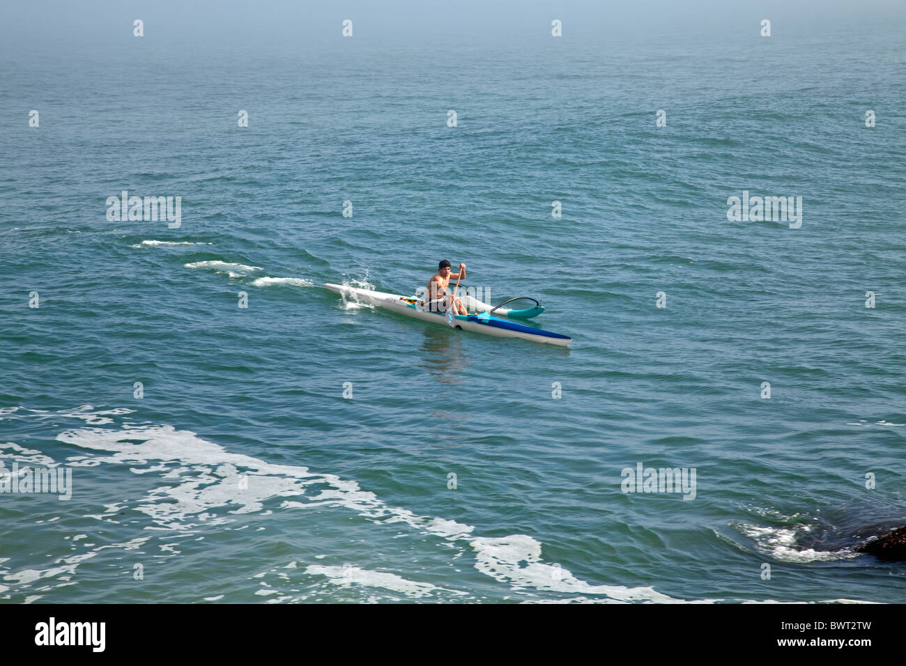 Kayaker riding surfing wave near Fort Point and Golden Gate Bridge, San ...