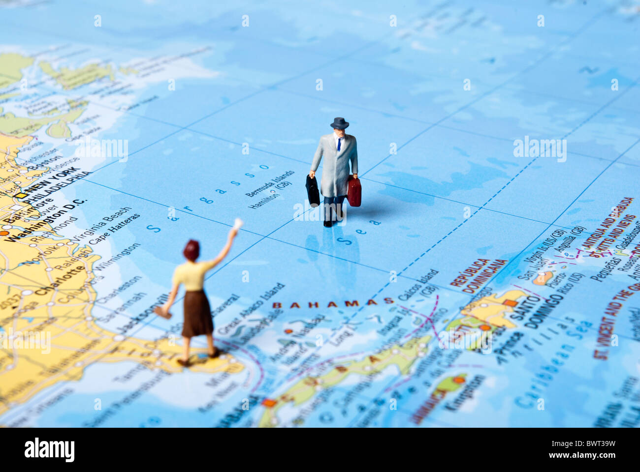 miniature man on world map Stock Photo - Alamy