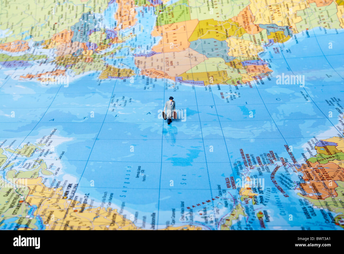 miniature man on world map Stock Photo - Alamy