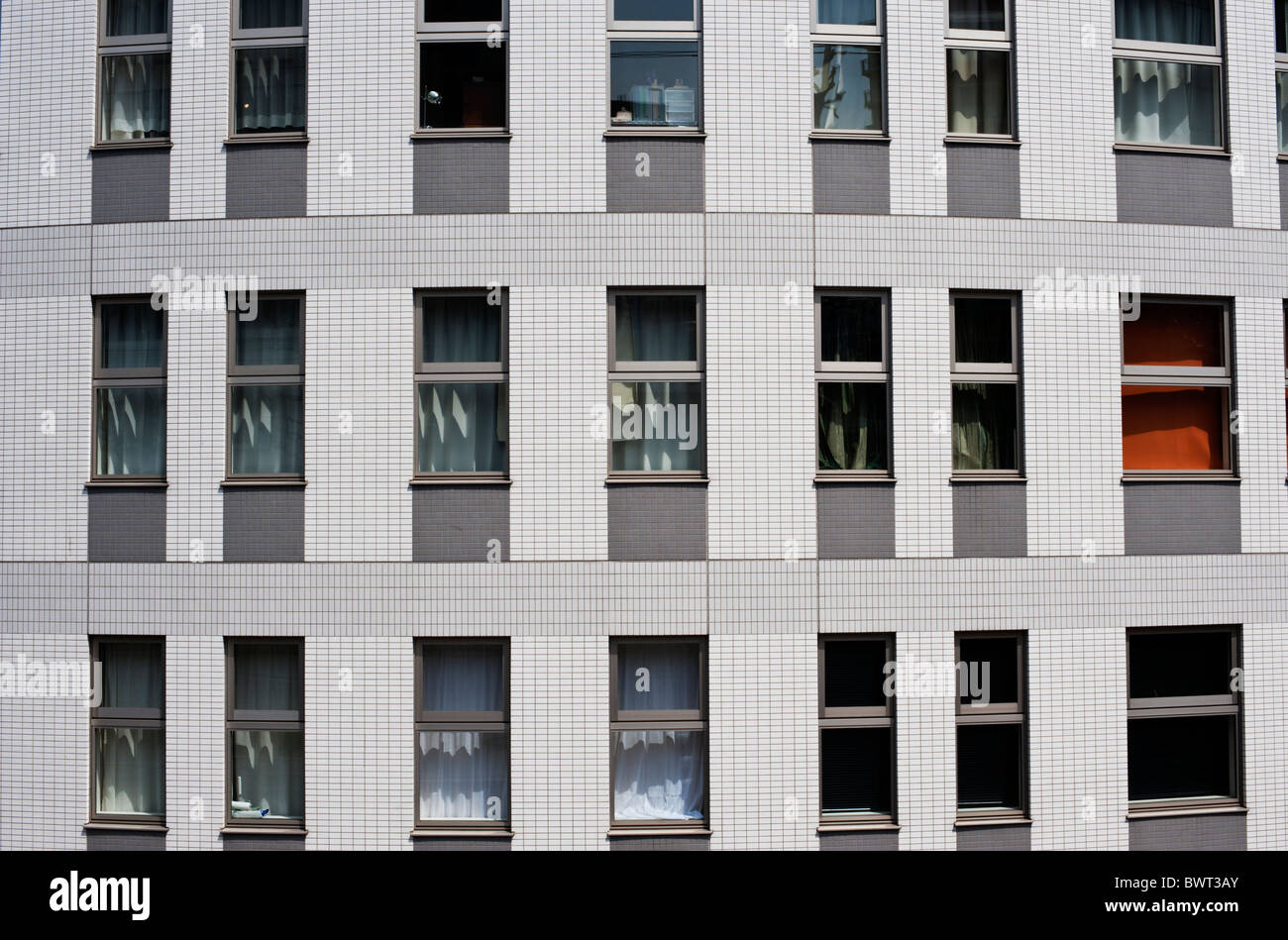 The long rectangular windows in an apartment building in downtown Tokyo ...