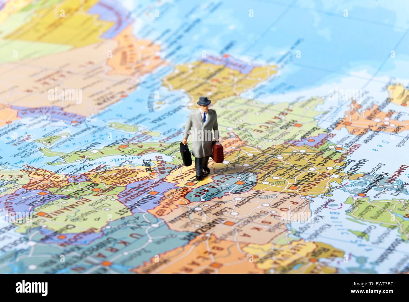 miniature man on world map Stock Photo - Alamy