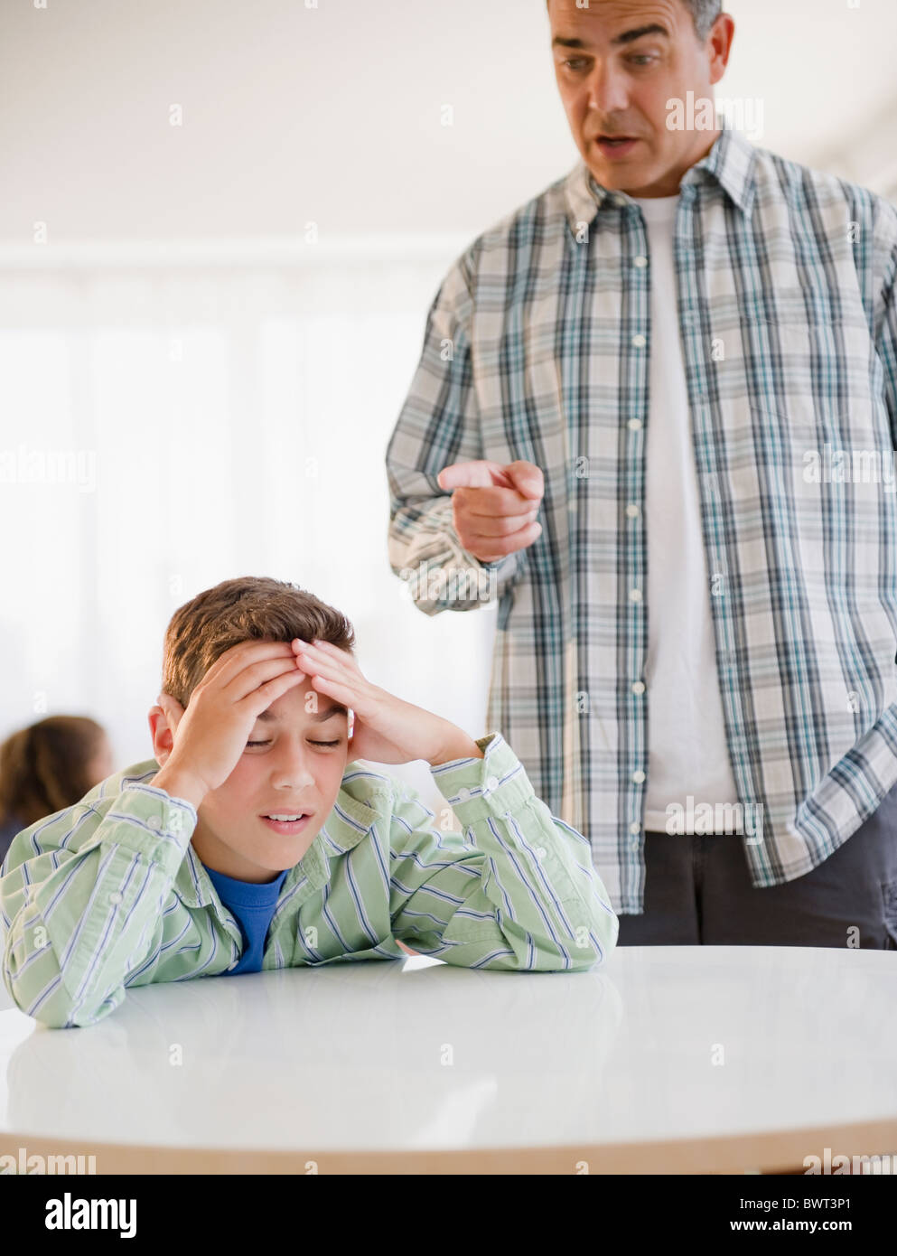 Hispanic father lecturing frustrated son Stock Photo - Alamy