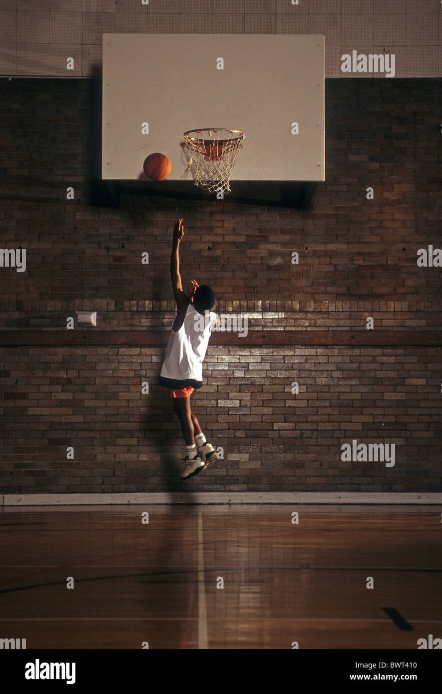 Young boy practicing his basketball shooting Stock Photo - Alamy