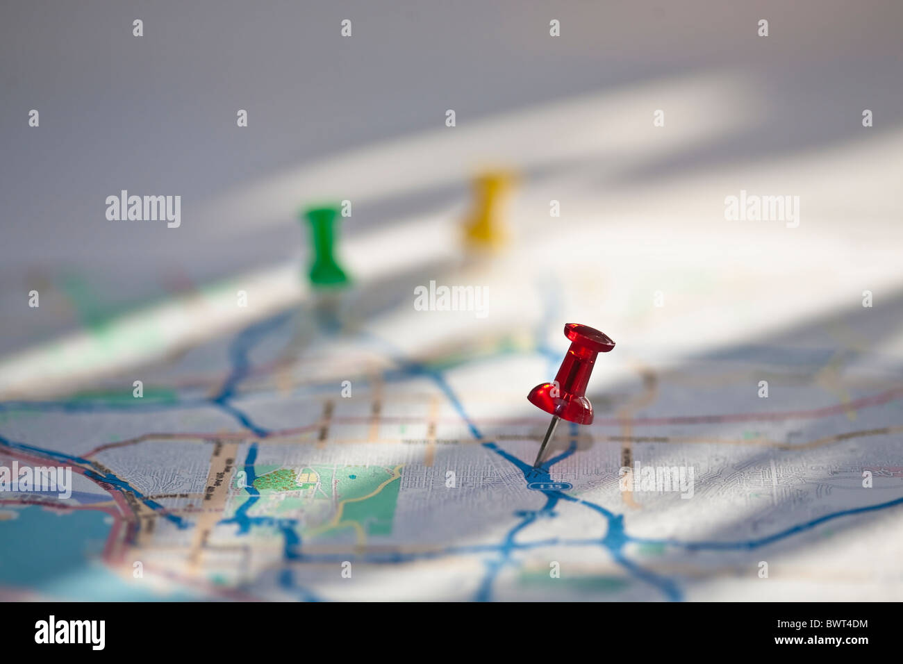 colored push-pins in colorful paper map Stock Photo - Alamy