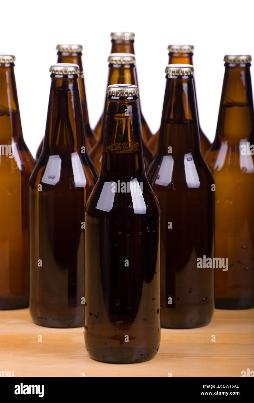 dark brown glass bottles full of beer on white Stock Photo - Alamy