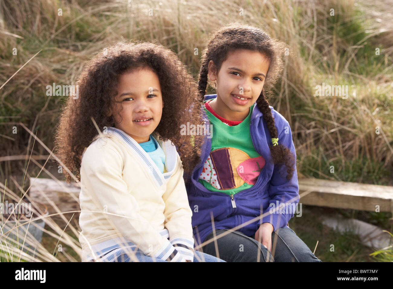 Young Girls Playing In Field Together Stock Photo - Alamy