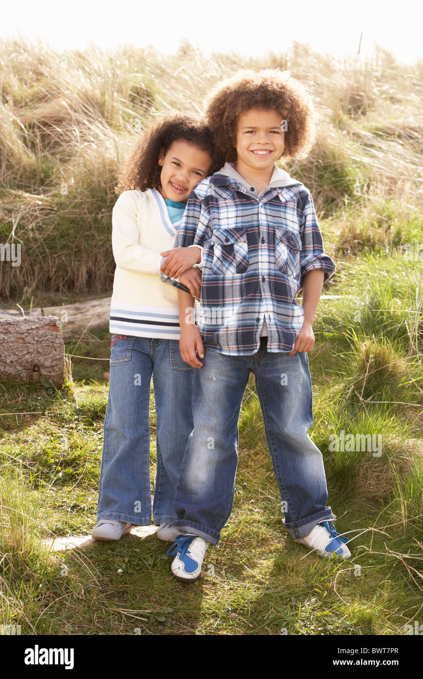 Boy And Girl Playing In Field Together Stock Photo - Alamy