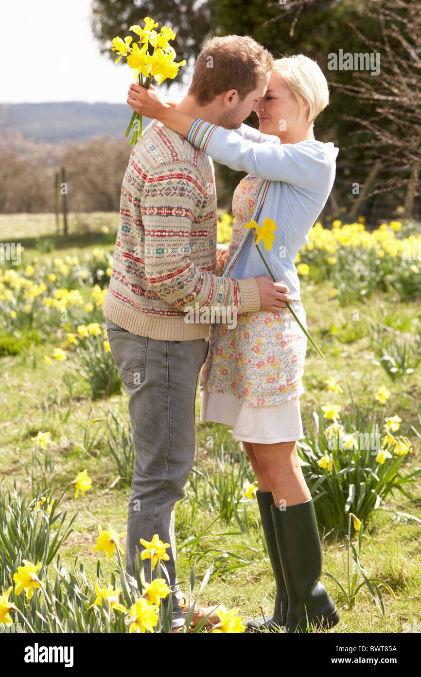 Romantic Couple Walking Amongst Spring Daffodils Stock Photo - Alamy