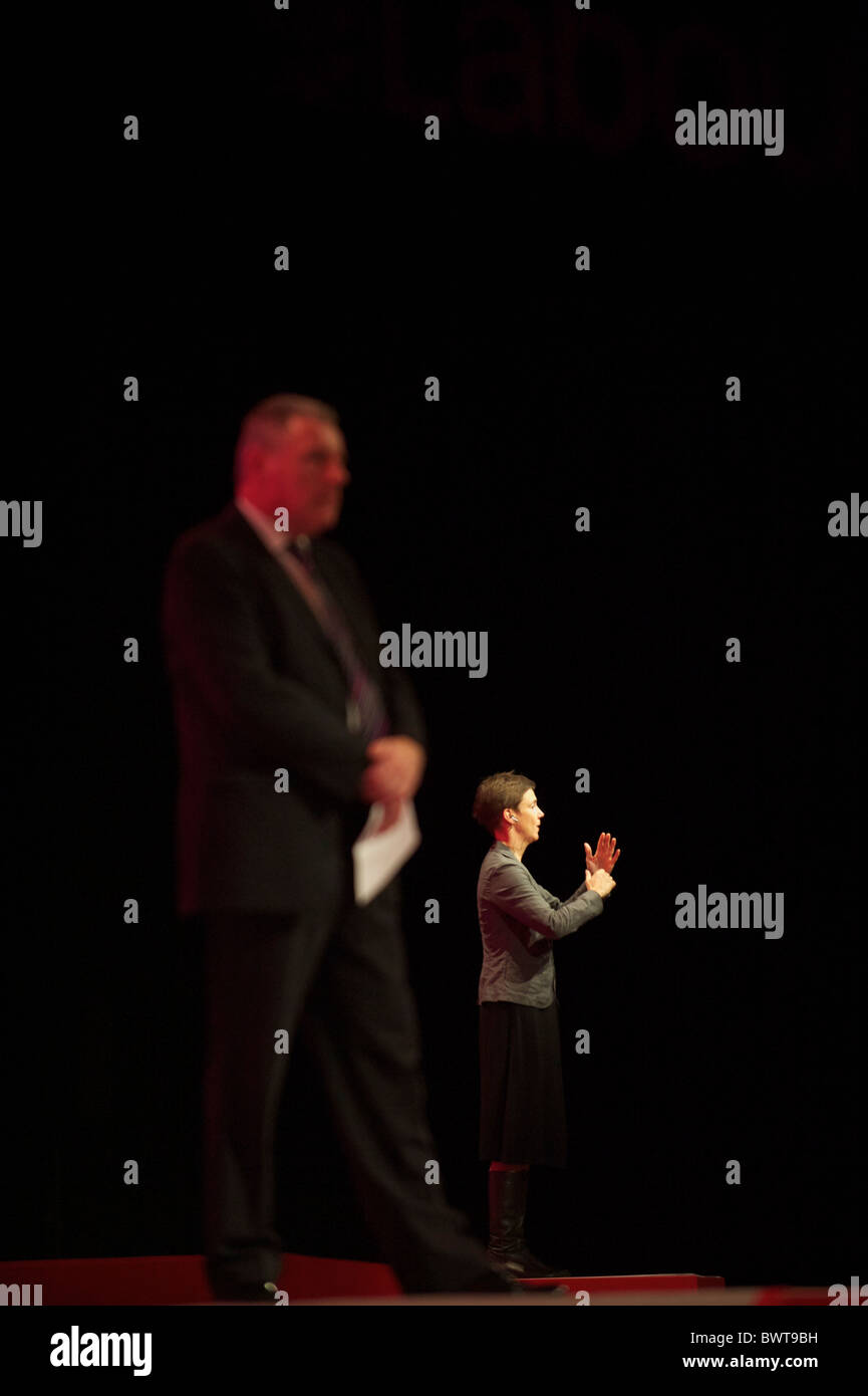 A sign language interpreter commnicates to the audience while a party ...