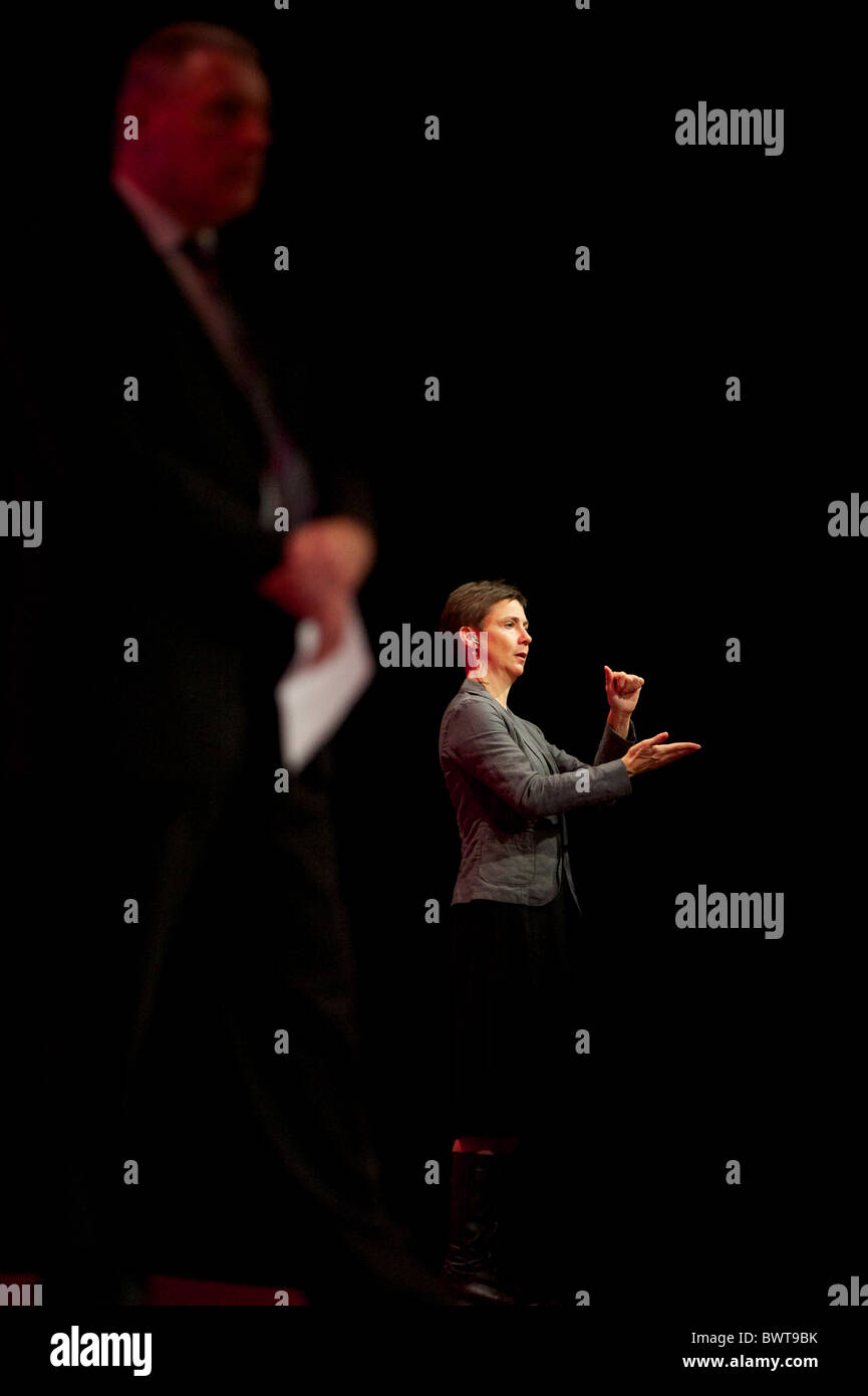 A sign language interpreter commnicates to the audience while a party ...